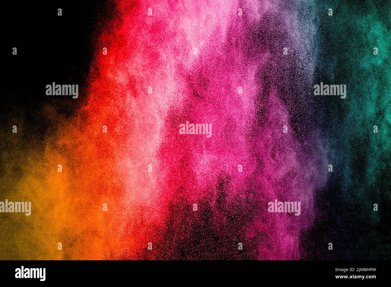 Multicolored powder explosion on black background.. Freeze motion of ...