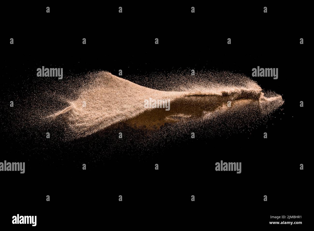 Dry river sand explosion. Golden colored sand splash against dark ...