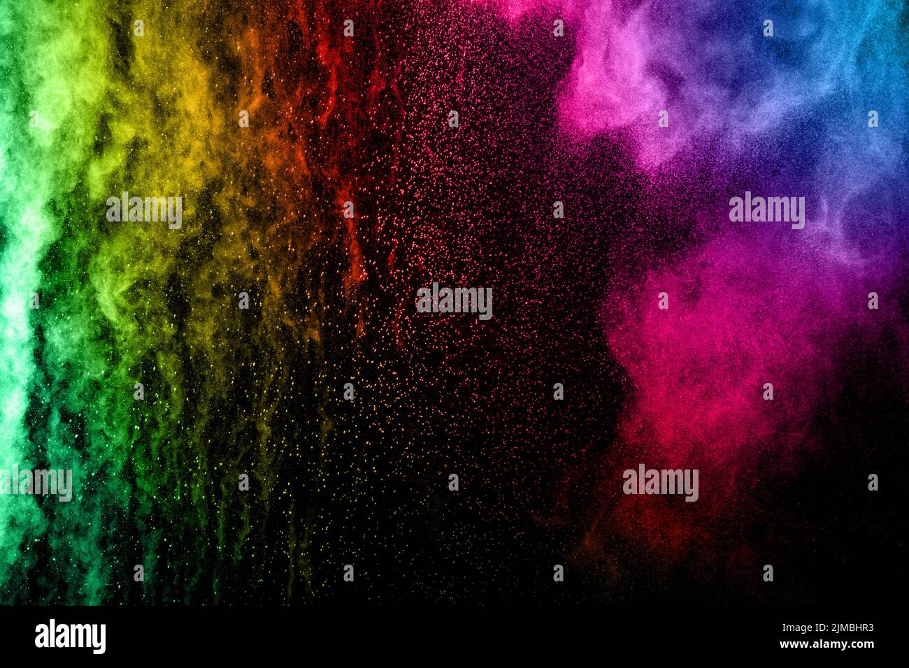 Abstract multicolored powder explosion on black background. Color dust ...