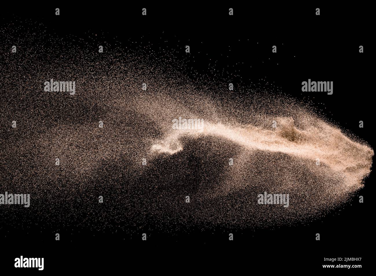 Dry river sand explosion. Golden colored sand splash against dark ...