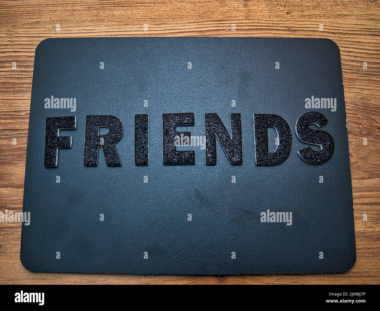 The word Friends in black letters on a black chalkboard background ...
