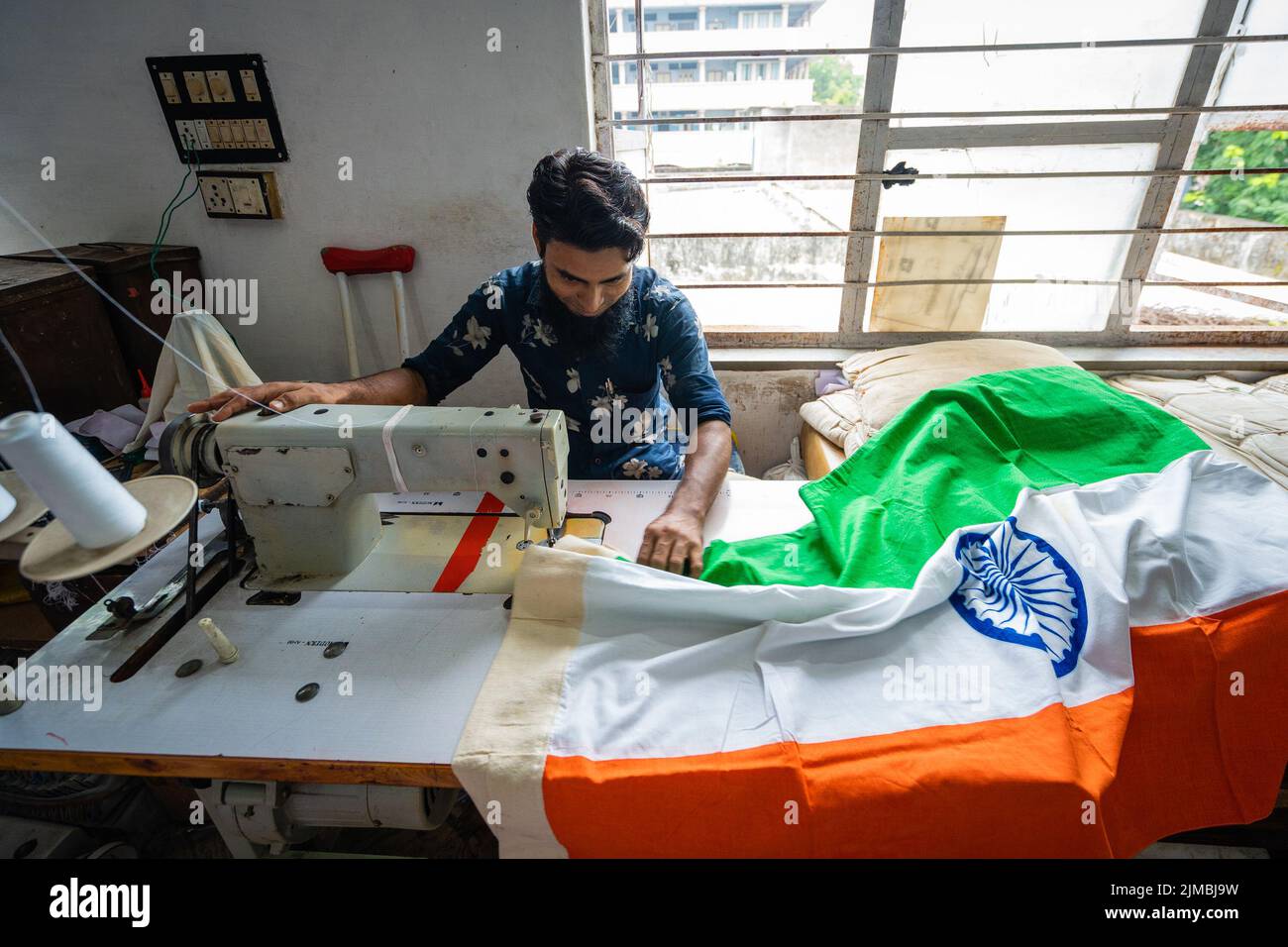 Ahmedabad, Gujarat, India. 5th Aug, 2022. Workers are making Tri-colour ...