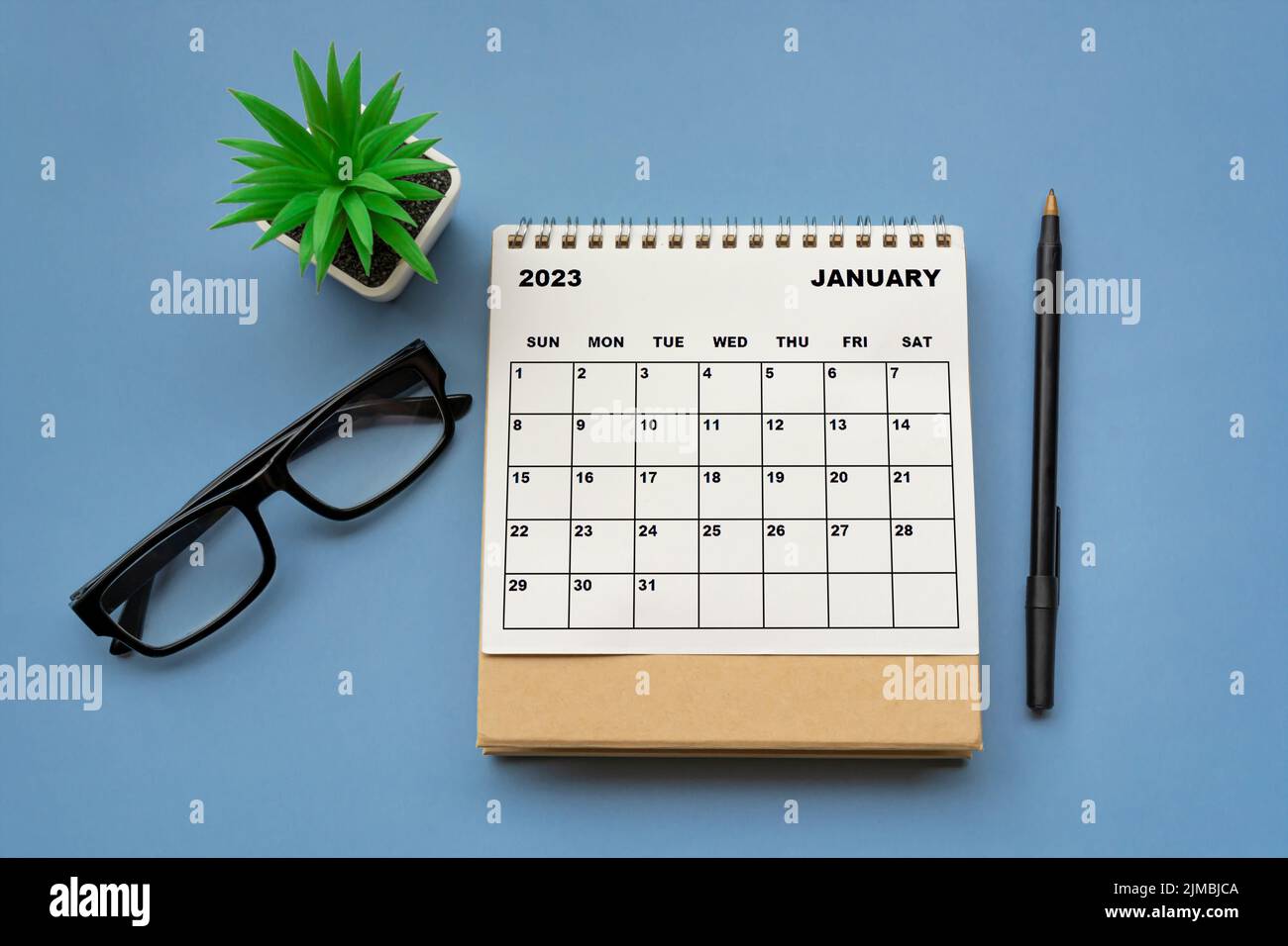 January 2023 desk calendar on blue background. Directly above Stock ...