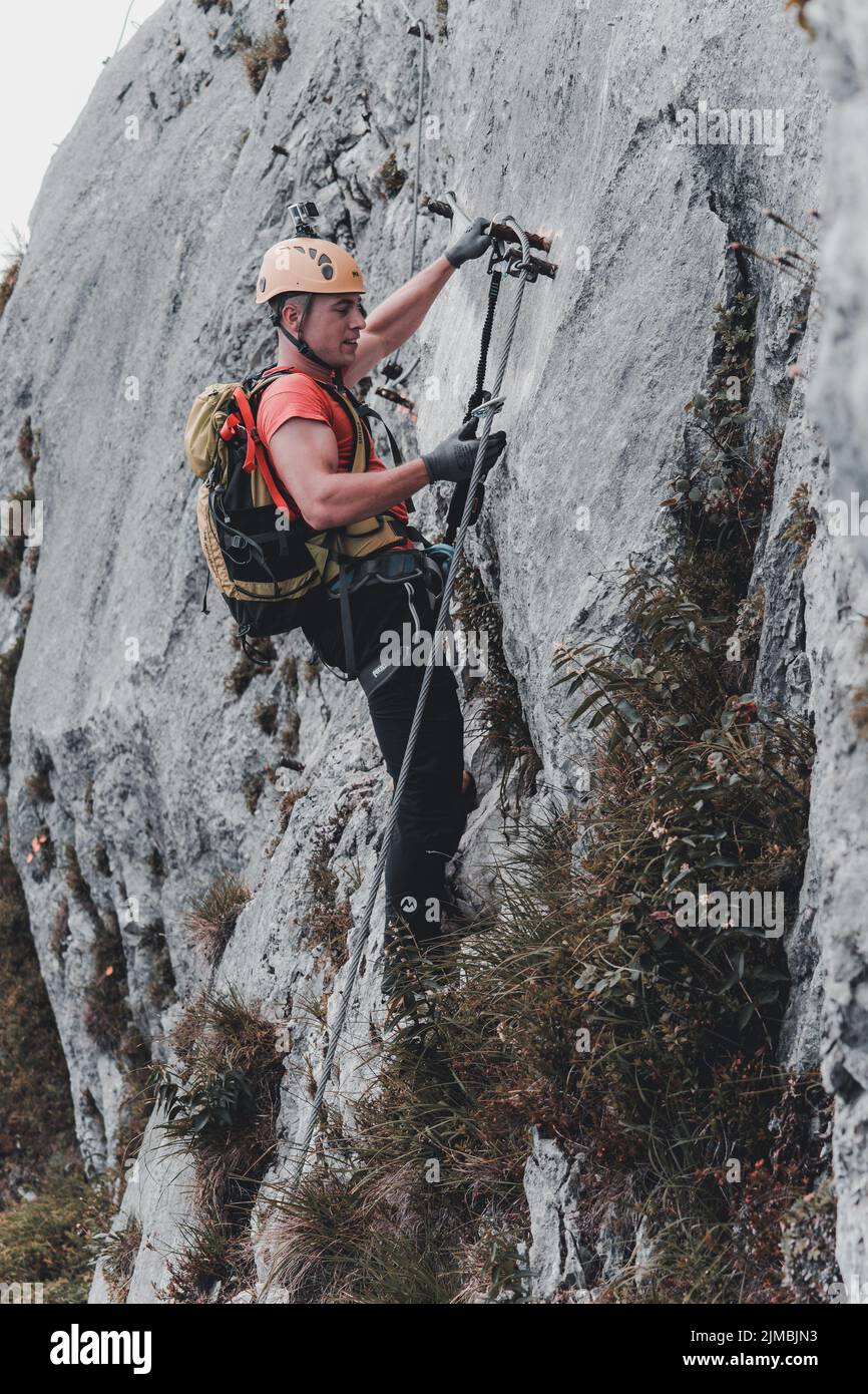 Young man climbing on rock hi-res stock photography and images - Alamy