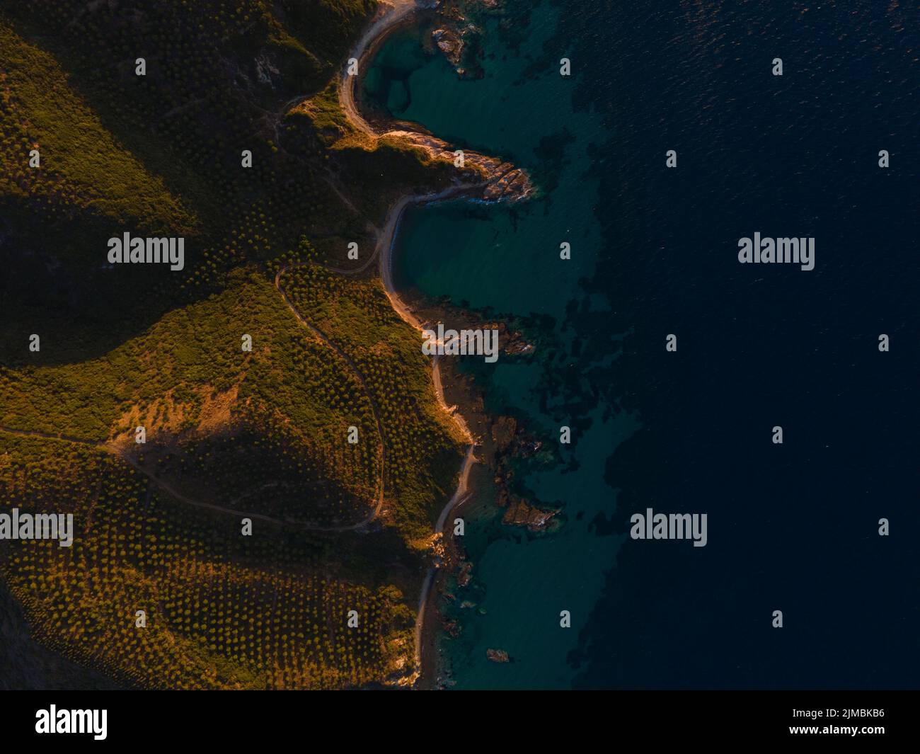 The aerial shot of the dark blue sea with a green shoreline. Canakkale ...