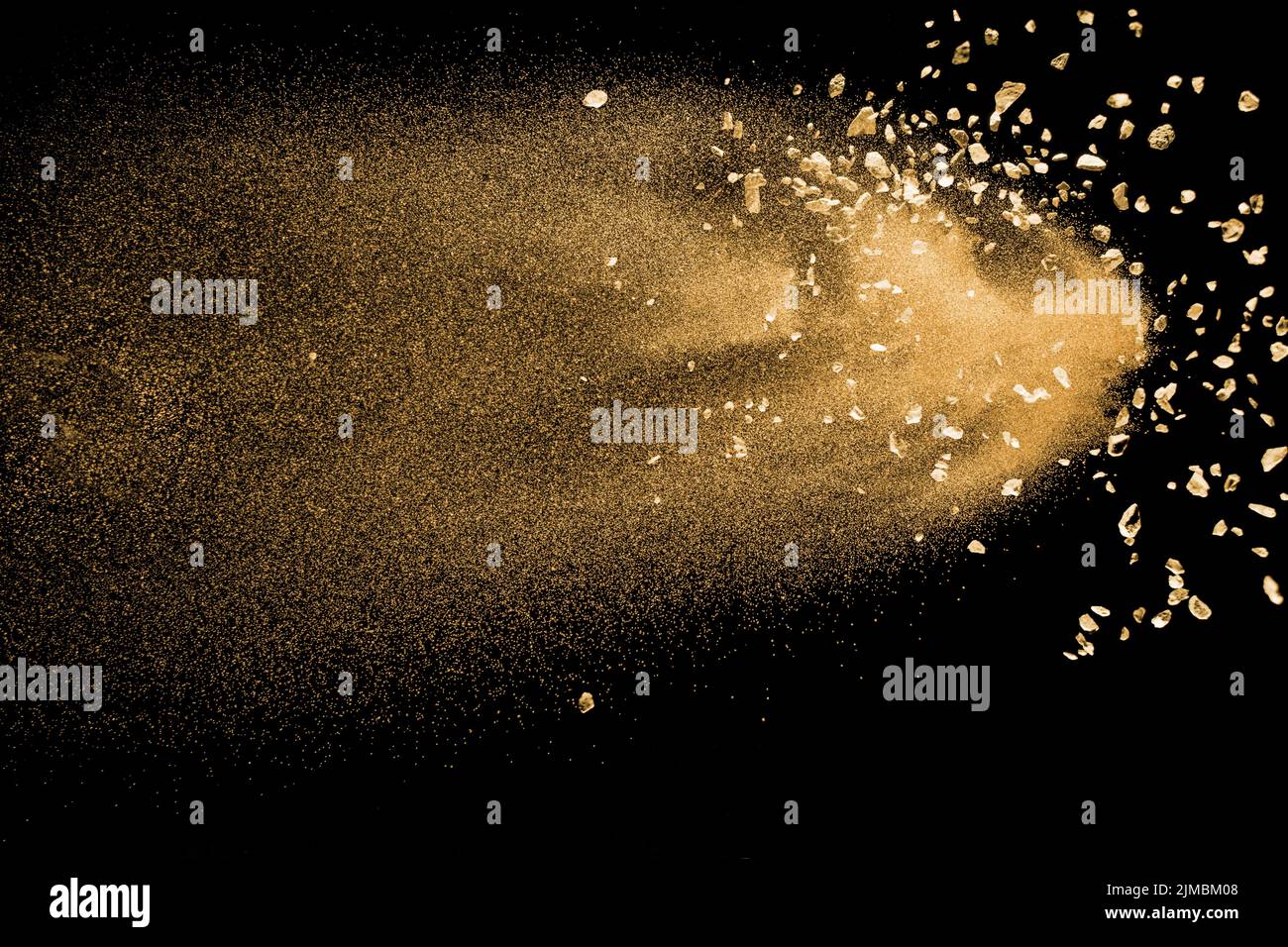 Dry river sand with stone explosion. Golden colored sand splash against ...