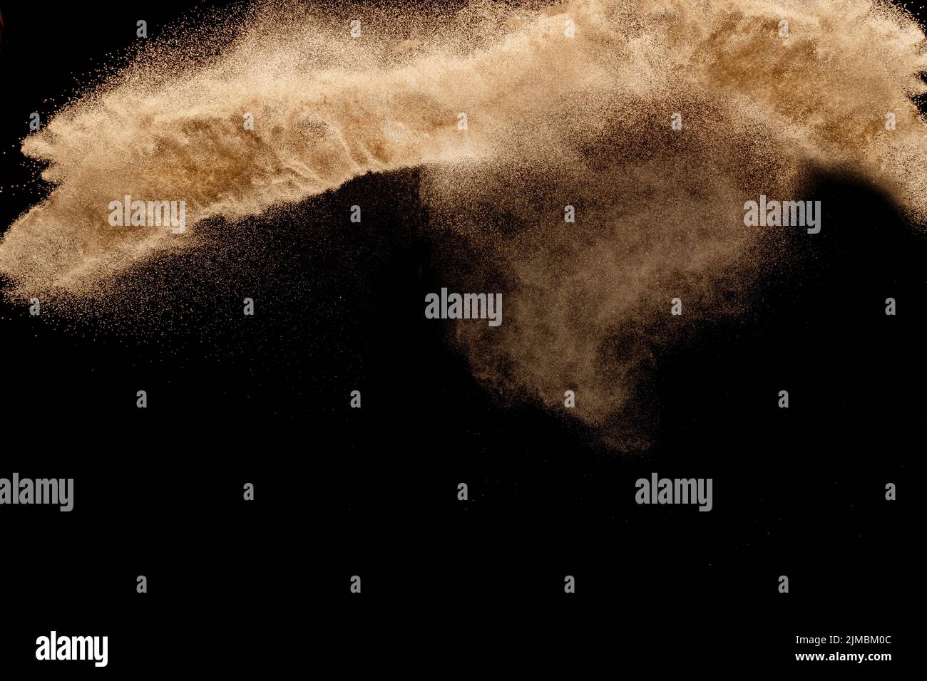 Dry river sand explosion. Yellow colored sand splash against dark ...