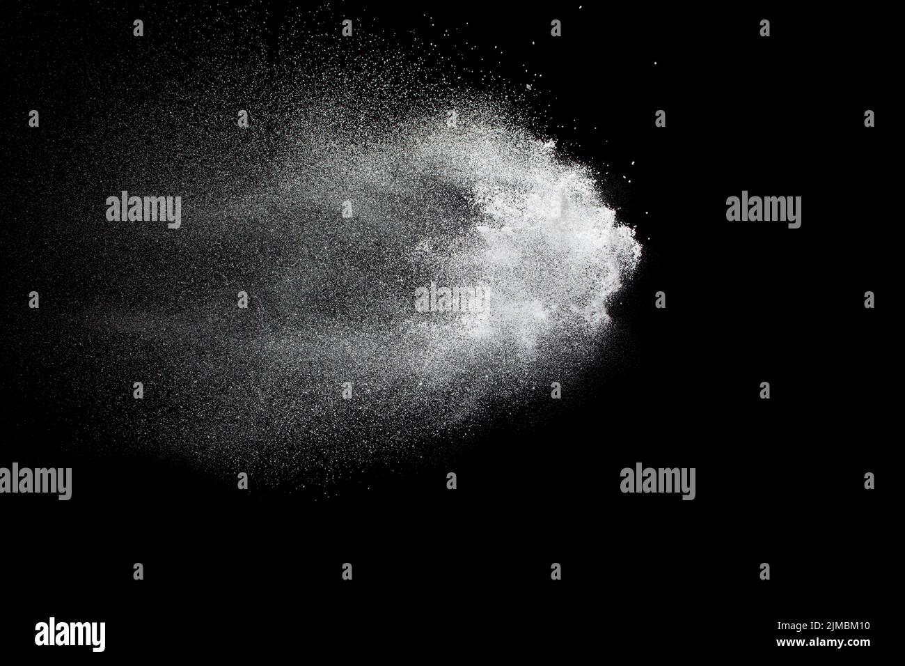 Bizarre forms of white powder explosion cloud against black background ...