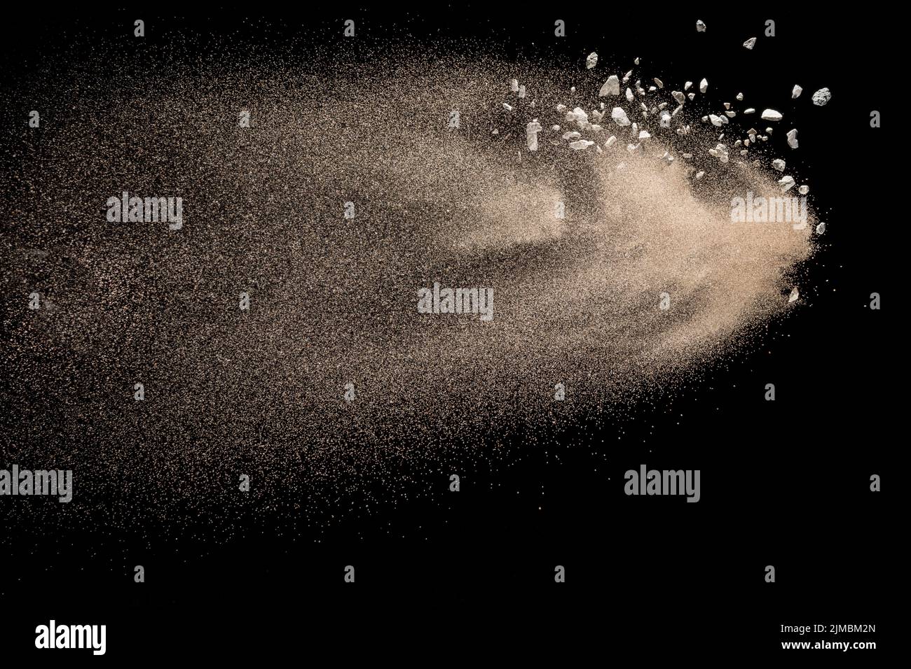 Dry river sand with stone explosion. Golden colored sand splash against ...