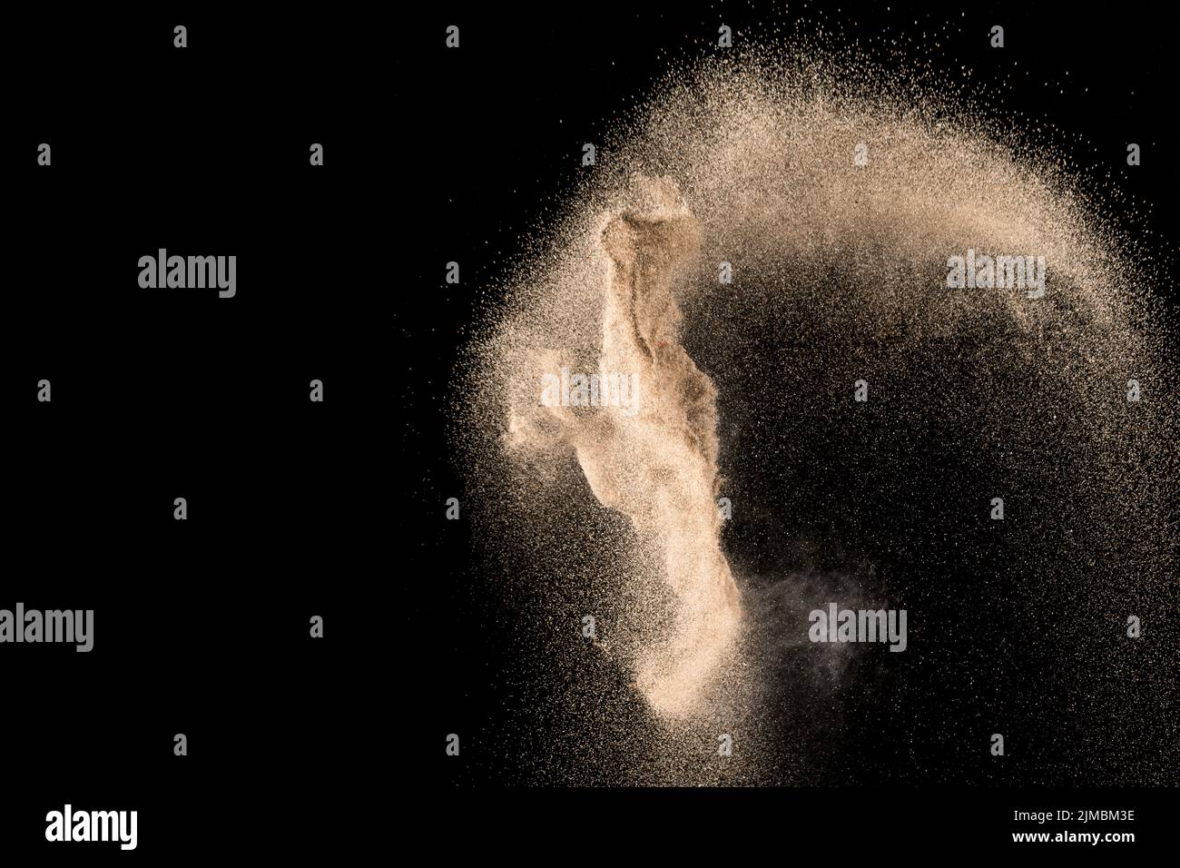 Dry river sand with stone explosion. Yellow colored sand splash agianst ...