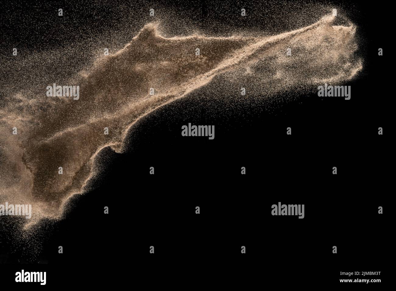 Dry river sand with stone explosion. Yellow colored sand splash against ...