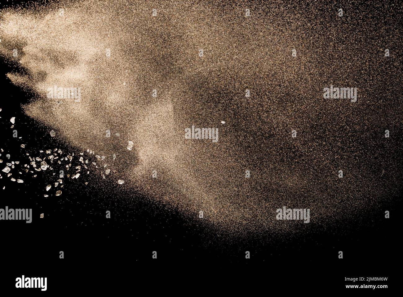 Dry river sand explosion. Golden colored sand splash against black ...