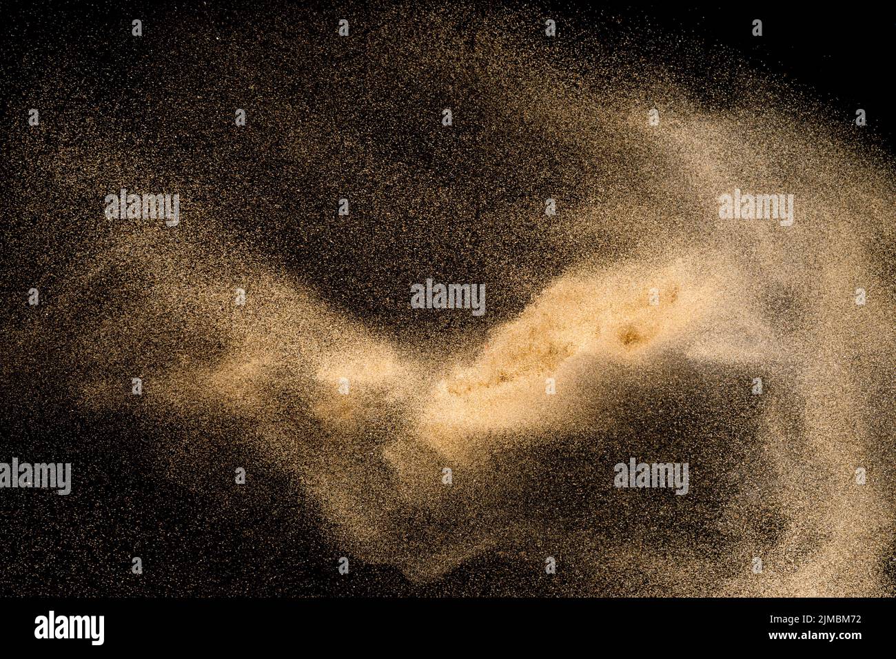 Dry river sand with stone explosion. Yellow colored sand splash against ...