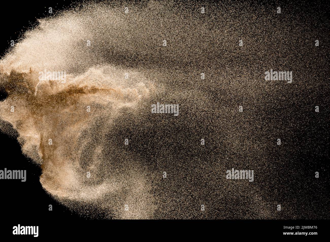 Dry river sand explosion. Golden colored sand splash against black ...