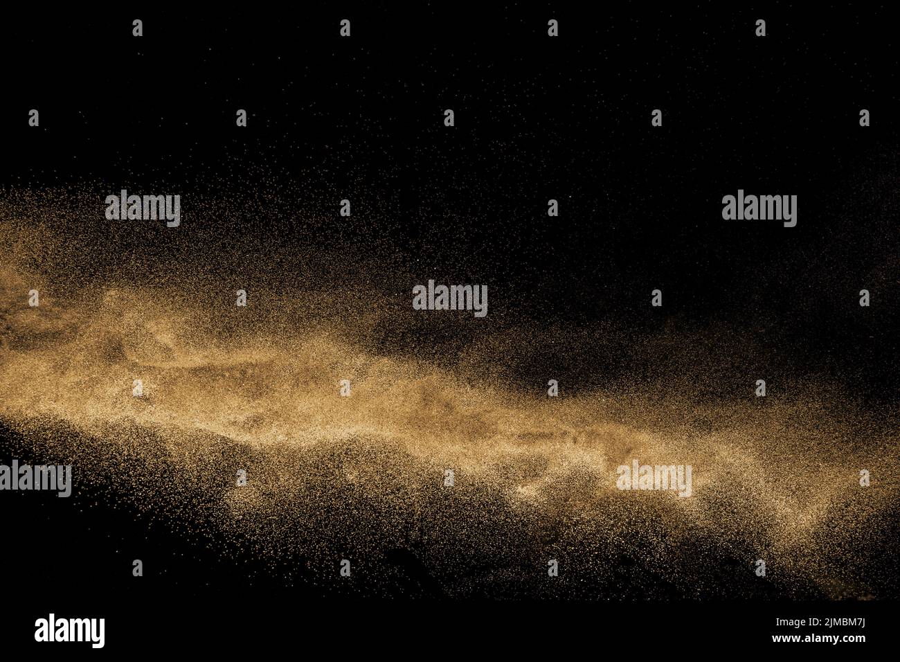 Dry river sand with stone explosion. Yellow colored sand splash agianst ...