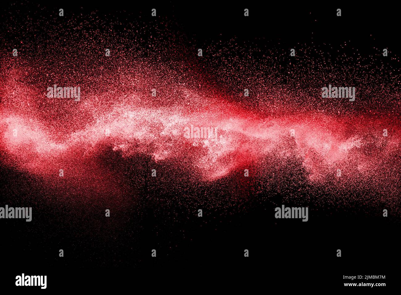 Red color powder explosion on black background.Freeze motion of red ...