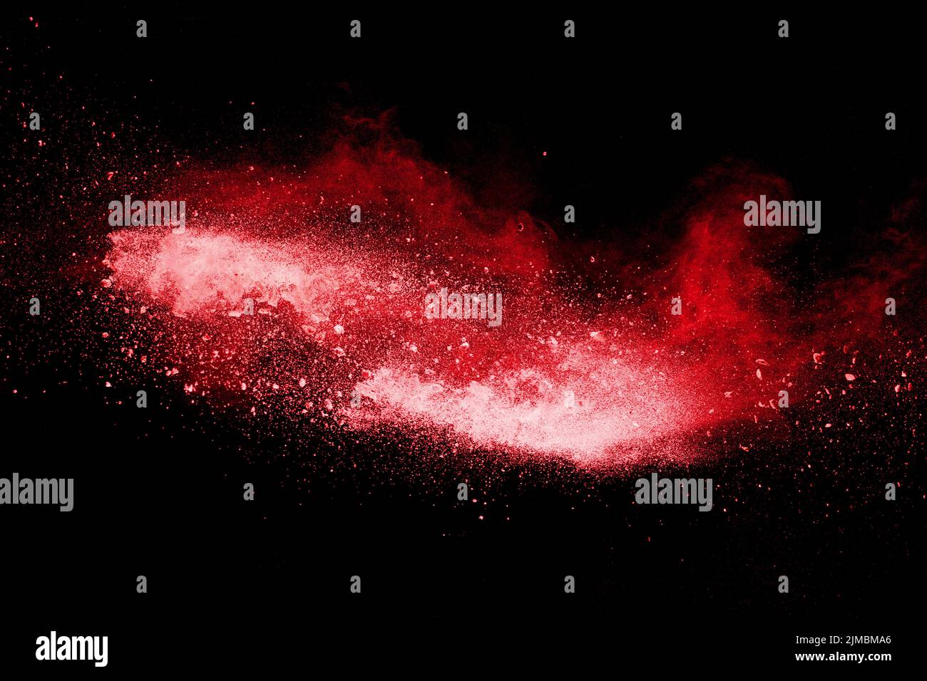 Red color powder explosion on black background.Freeze motion of red ...