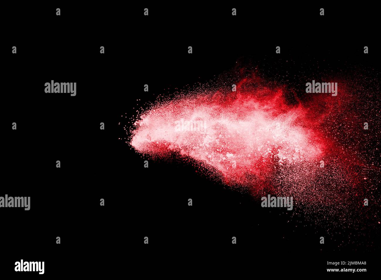 Red color powder explosion on black background.Freeze motion of red ...