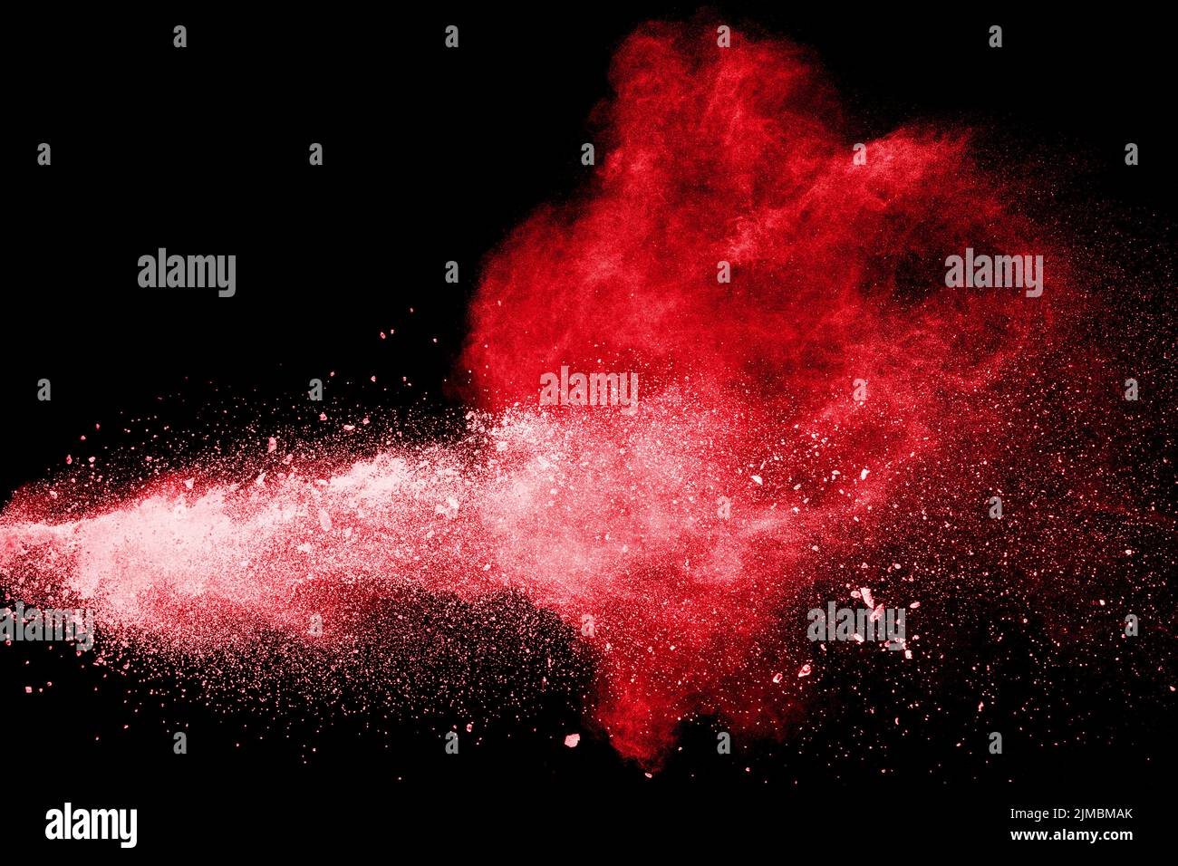 Red color powder explosion on black background.Freeze motion of red ...