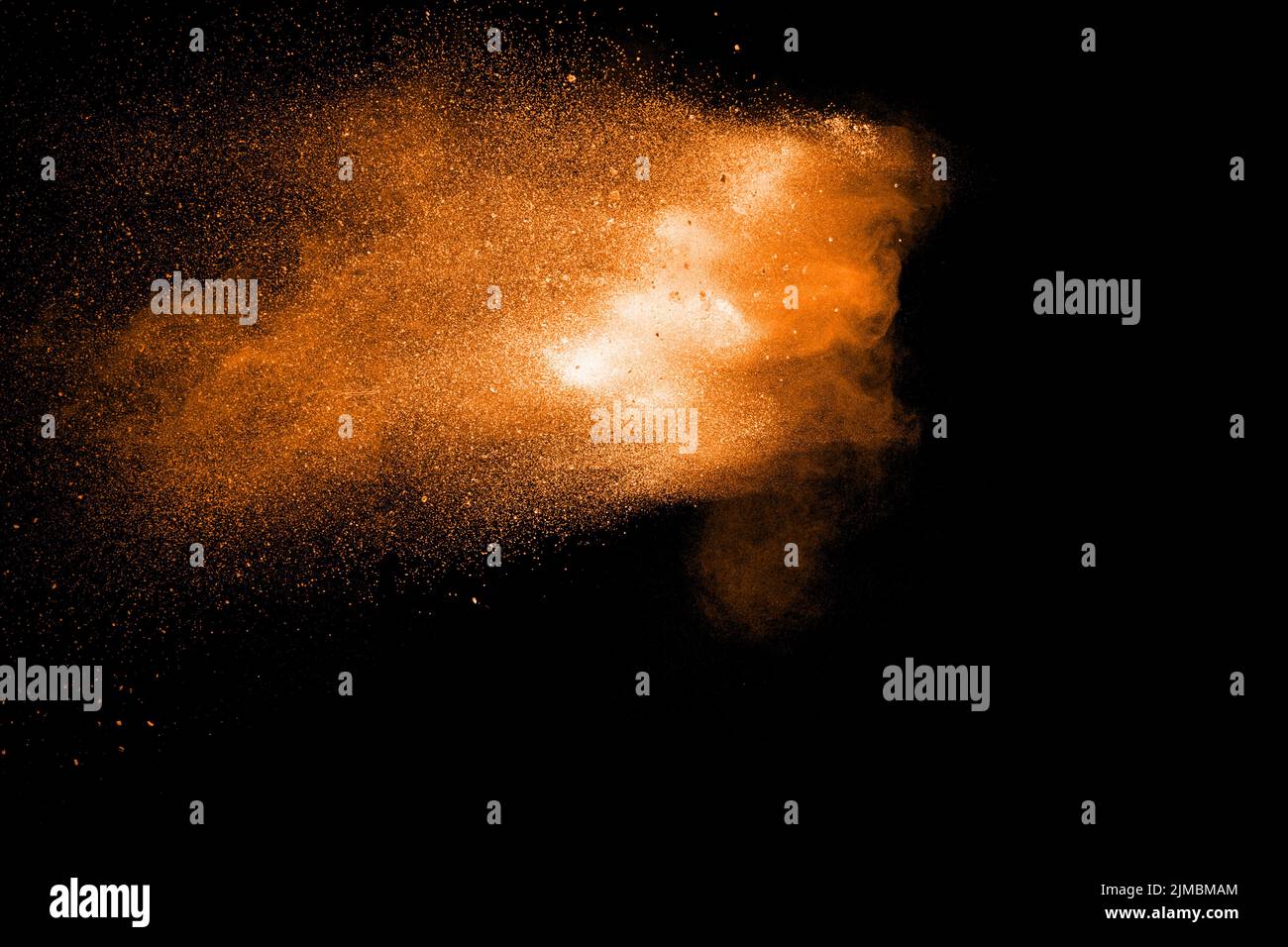 Orange color powder explosion on black background. Orange particles ...