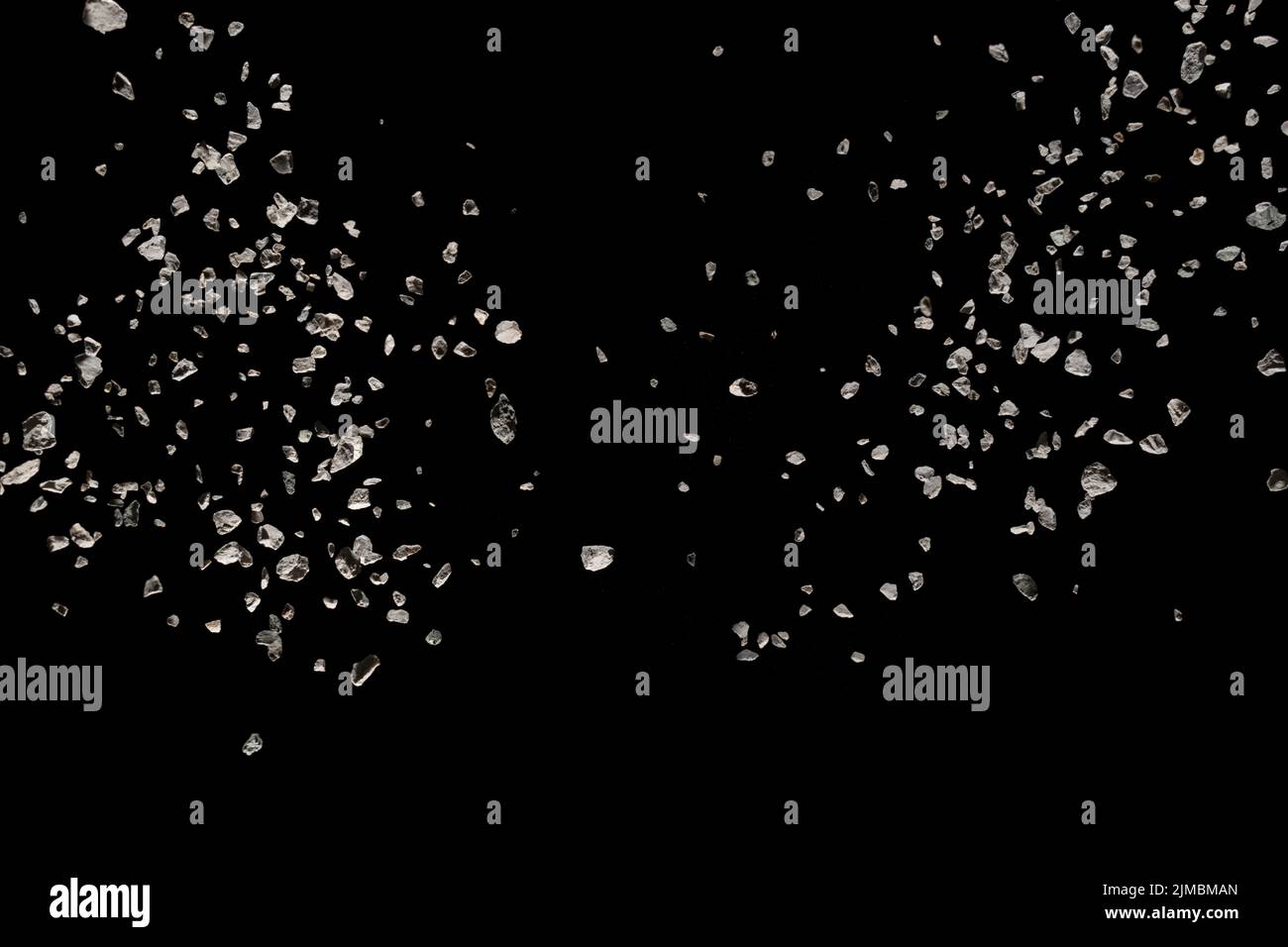 Split debris of stone exploding against black background Stock Photo ...