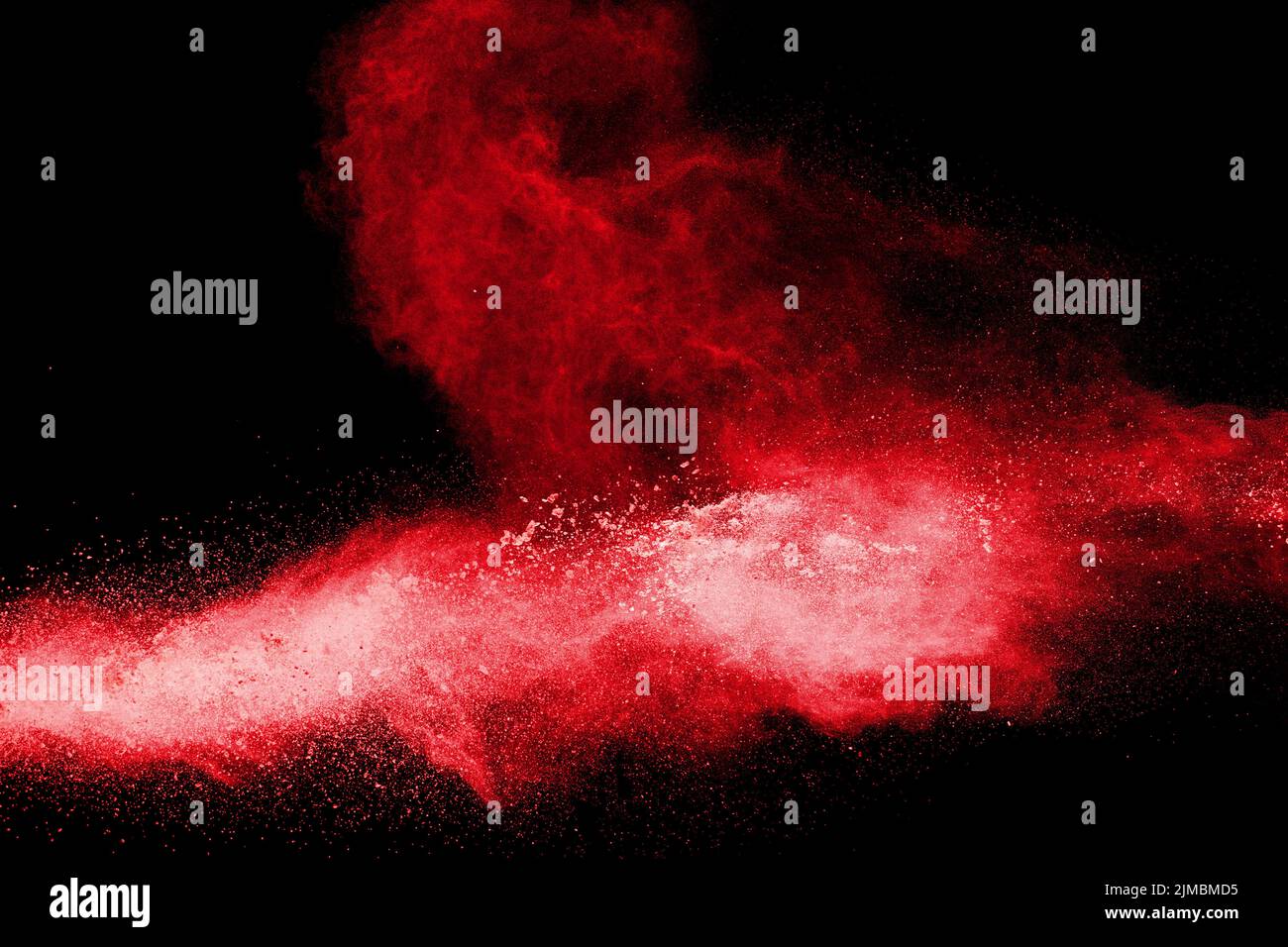 Red color powder explosion on black background.Freeze motion of red ...