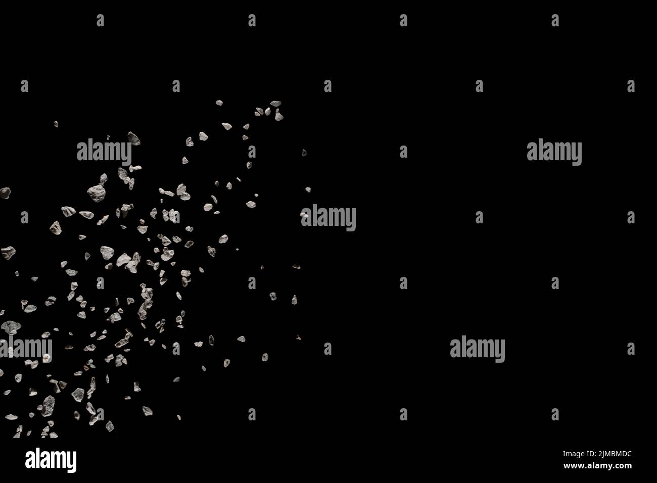 Split debris of stone exploding against black background Stock Photo ...
