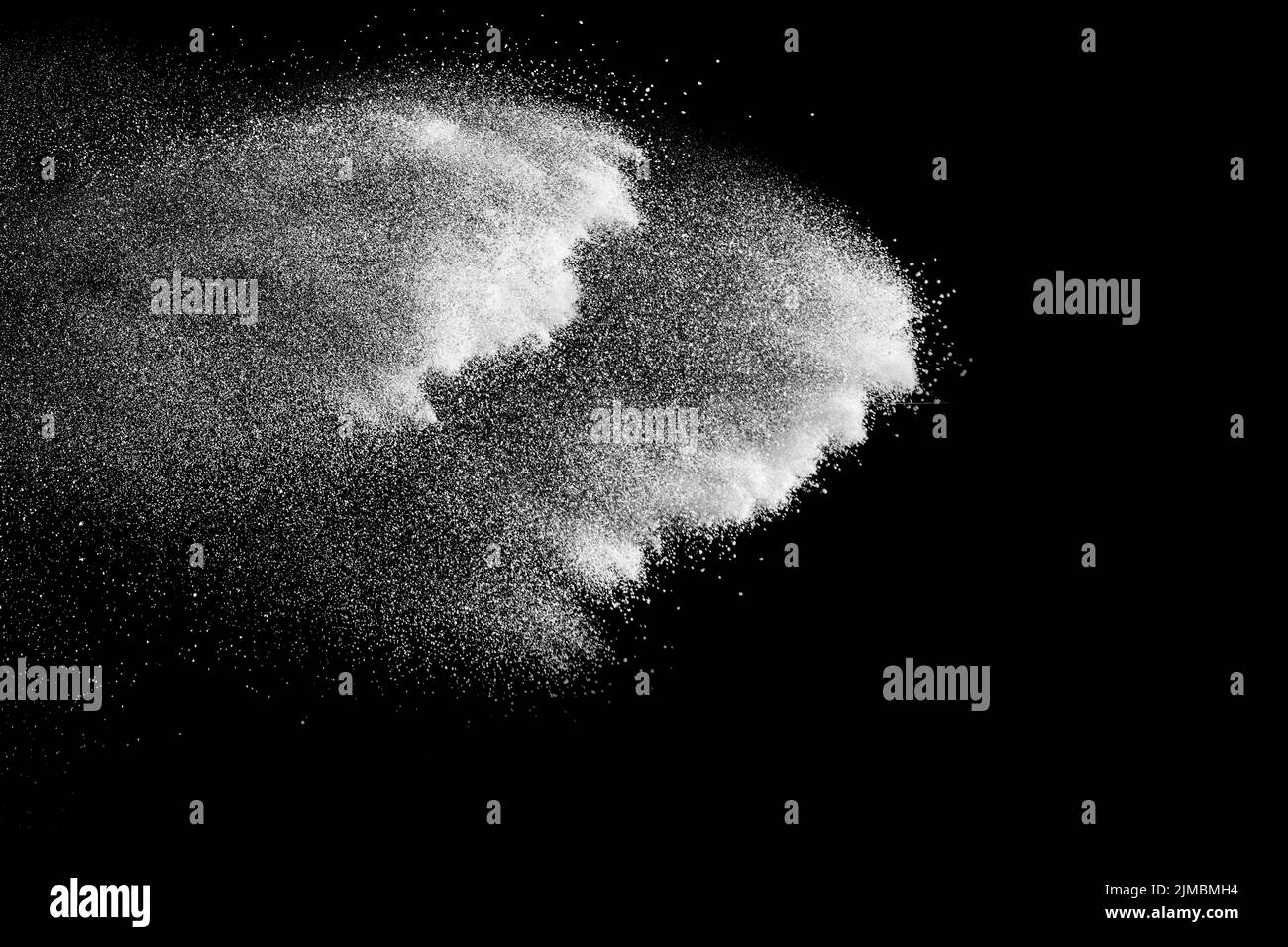 White powder explosion cloud against black background.White dust ...