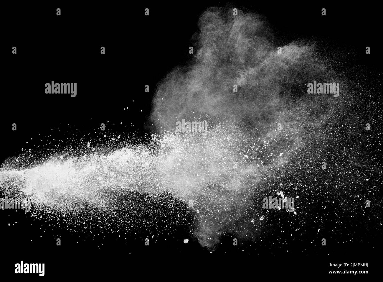 Bizarre forms of white powder explosion cloud against black background ...