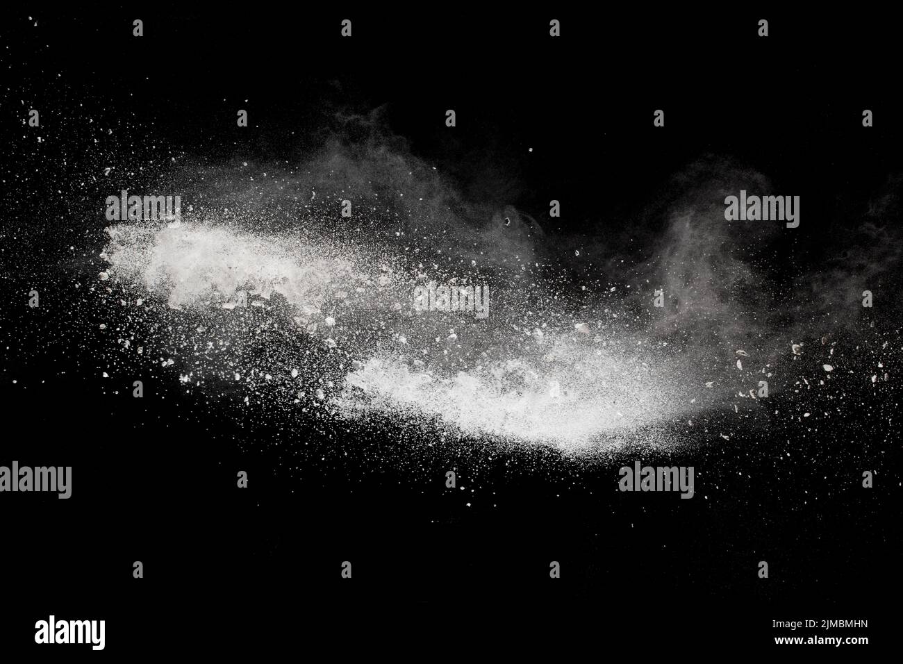 Bizarre forms of white powder explosion cloud against black background ...