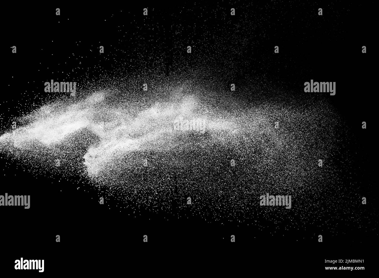 Bizarre forms of white powder explosion cloud against black background ...
