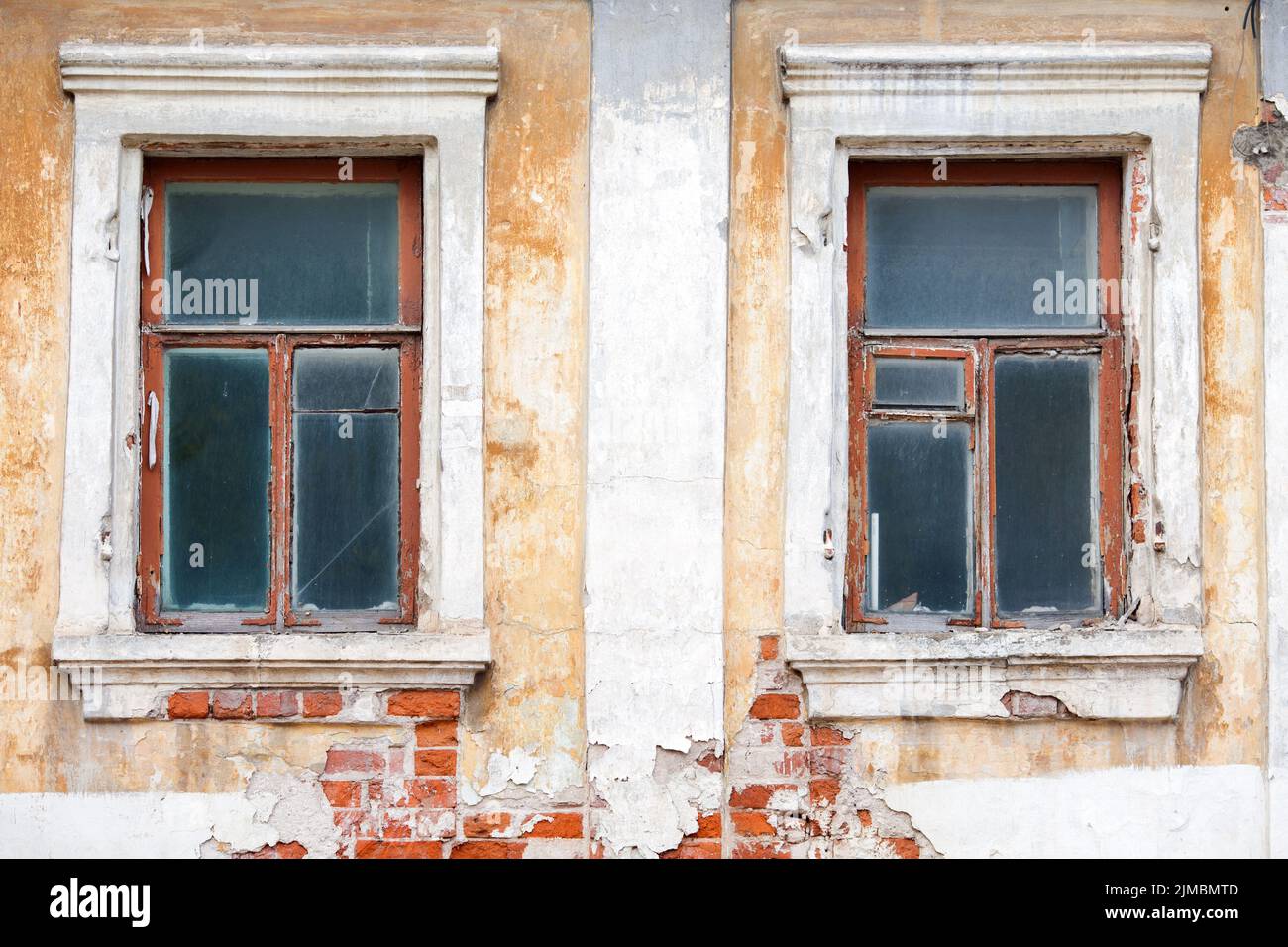Windows in an old house with damaged brick walls Stock Photo - Alamy