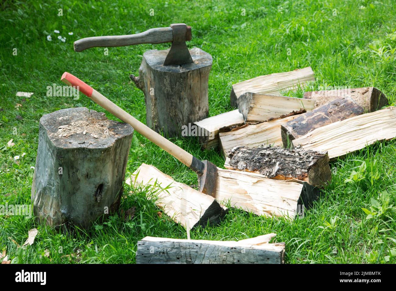 Ax and cleaver on chopped firewood on a summer day Stock Photo - Alamy