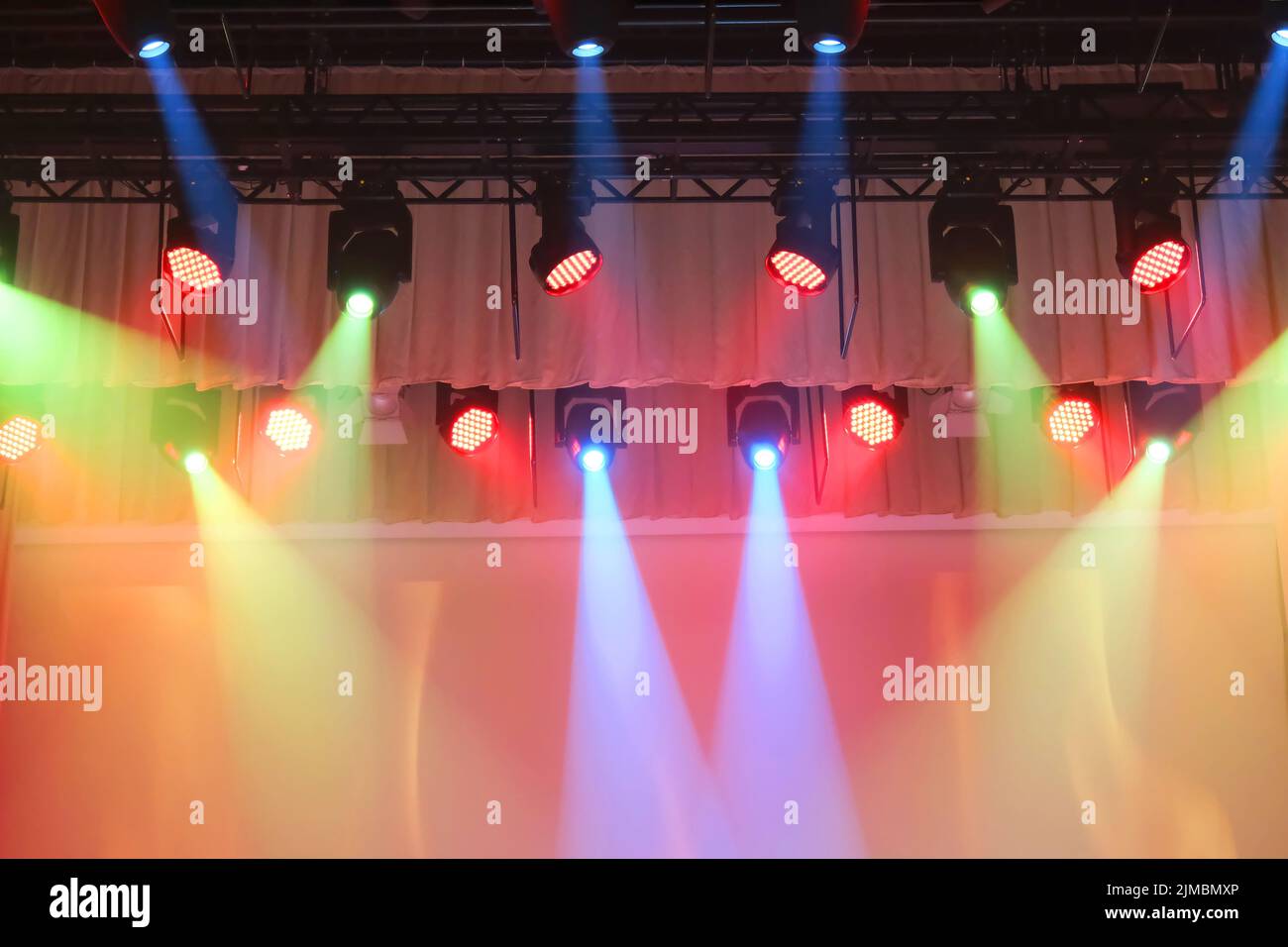 Stage with colorful lighting equipment. Multi-colored spotlights above ...