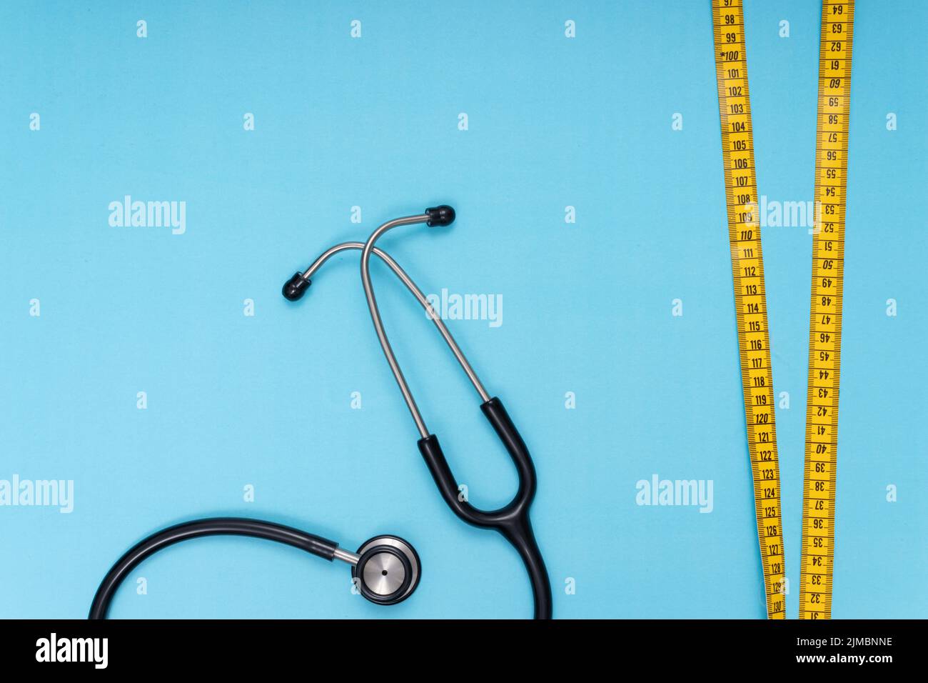 black stethoscope, tape measure, blue isolated background Stock Photo ...