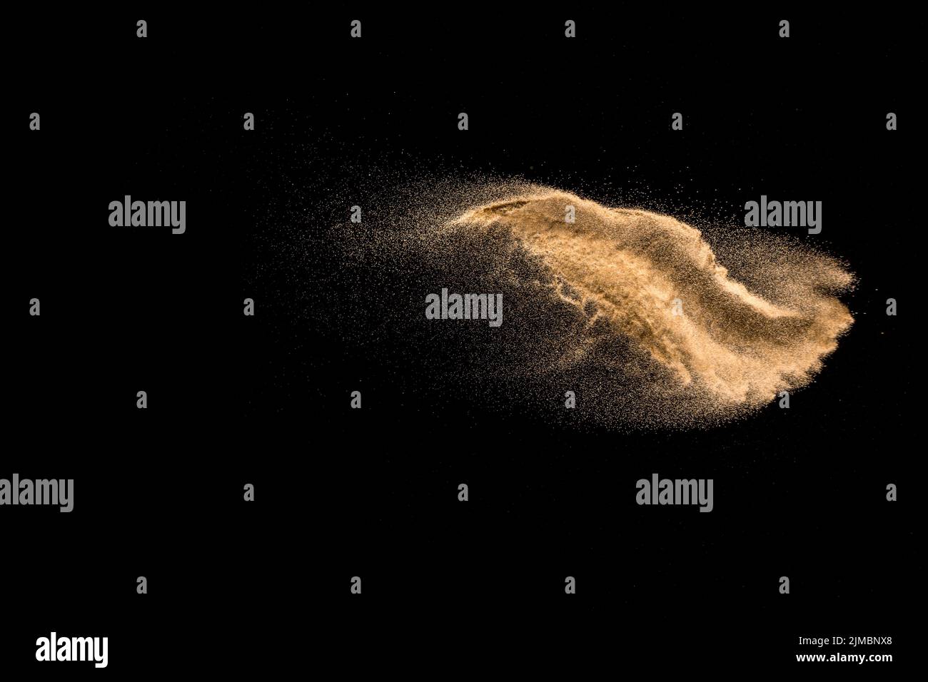 Golden sand explosion isolated on black background. Abstract sand cloud ...