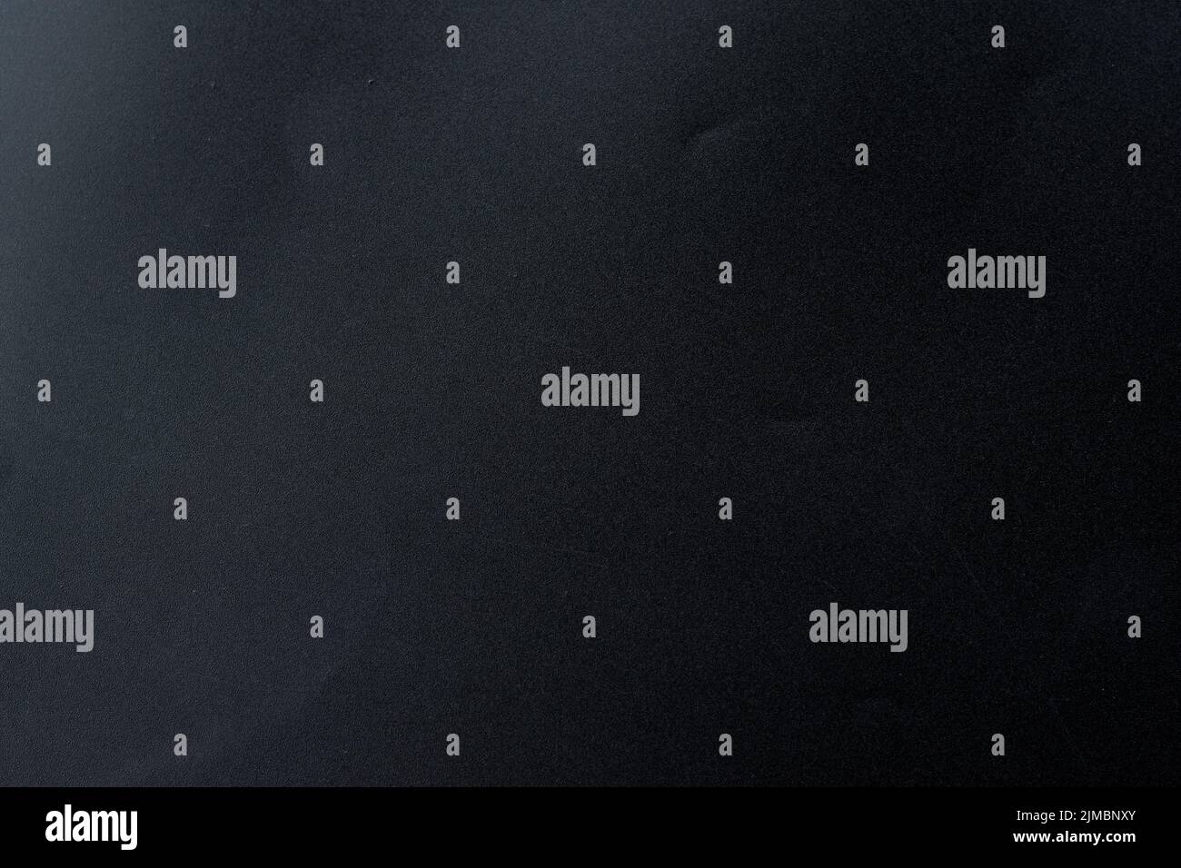 Black rough textured background lit with dim light at the angle Stock ...