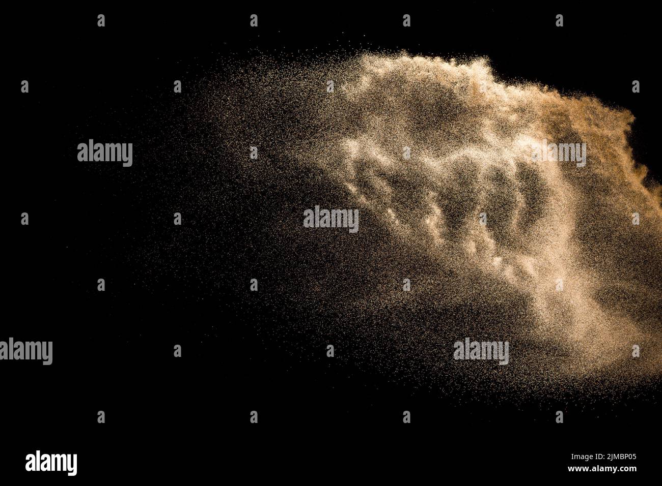 Golden sand explosion isolated on black background. Abstract sand cloud ...