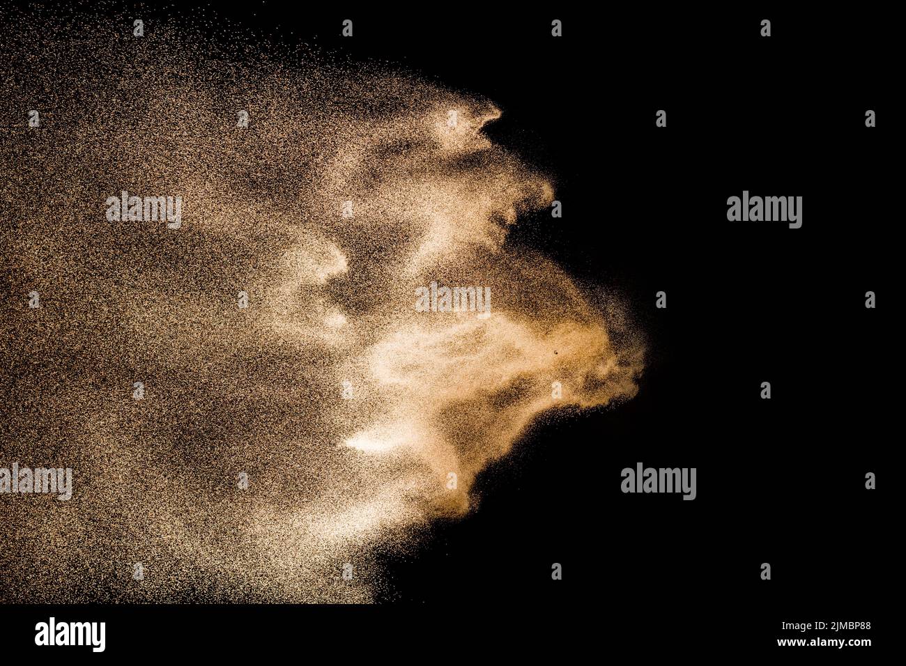 Golden sand explosion isolated on black background. Abstract sand cloud ...