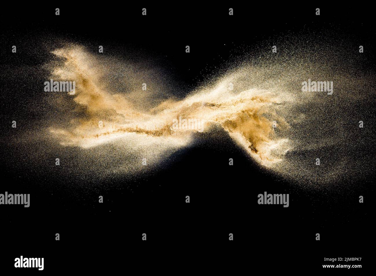 Golden sand explosion isolated on black background. Abstract sand cloud ...