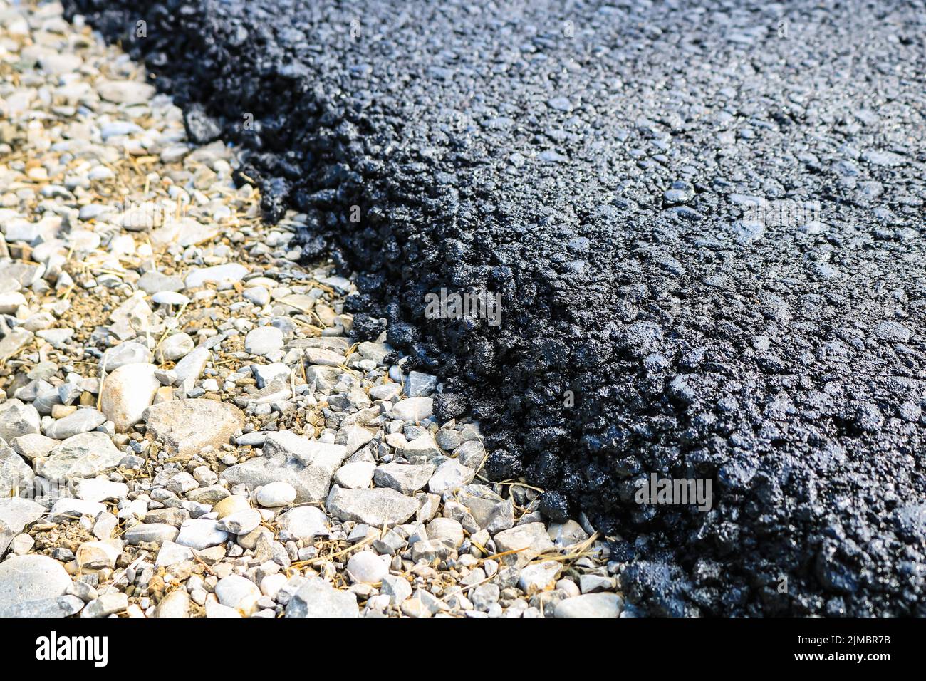 New layer of asphalt road under construction Stock Photo - Alamy