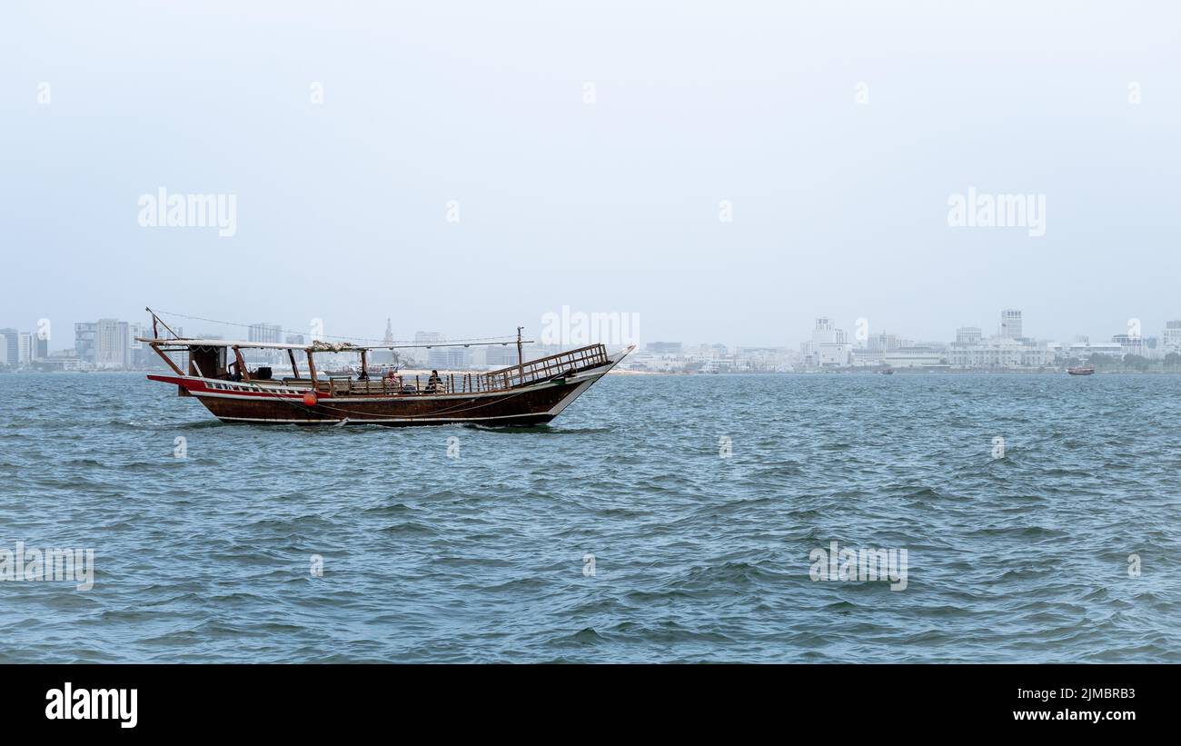 people riding on the traditional Dhow boats in qatar corniche Stock ...