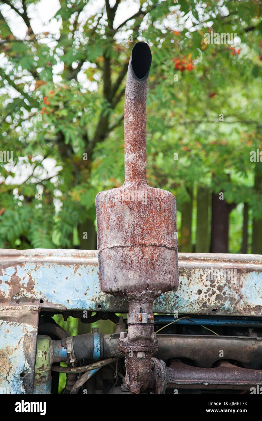 Old rusty tractor exhaust pipe in the summer close-up Stock Photo - Alamy