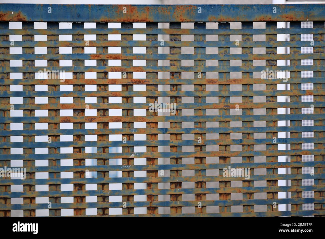 Old blue protective street metal iron grid, steel grating fence with ...