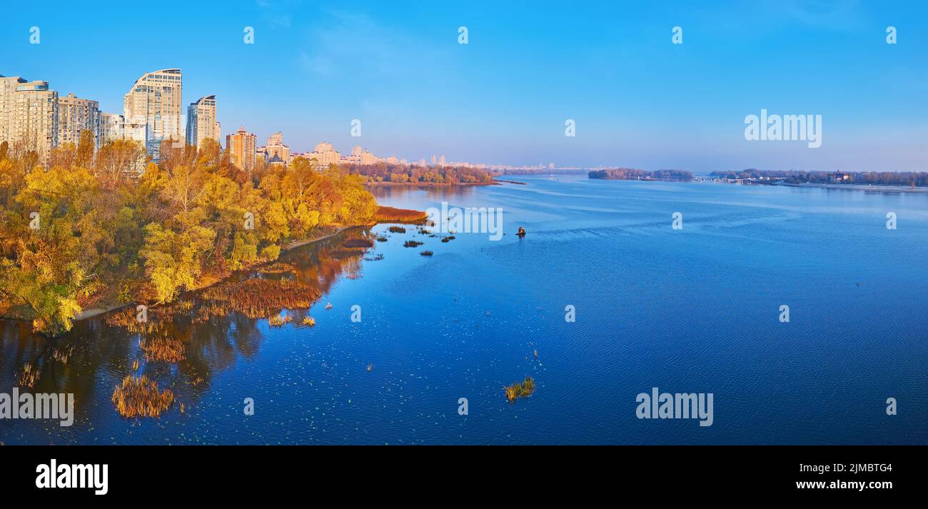 Obolon embankment of Dnieper River with autumn Natalka Park, modern ...