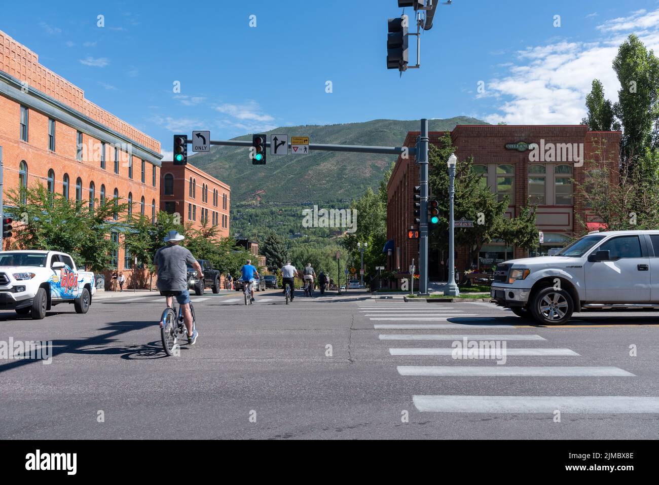 Bicyclists ride through the intersection of Mill and Main Streets in ...