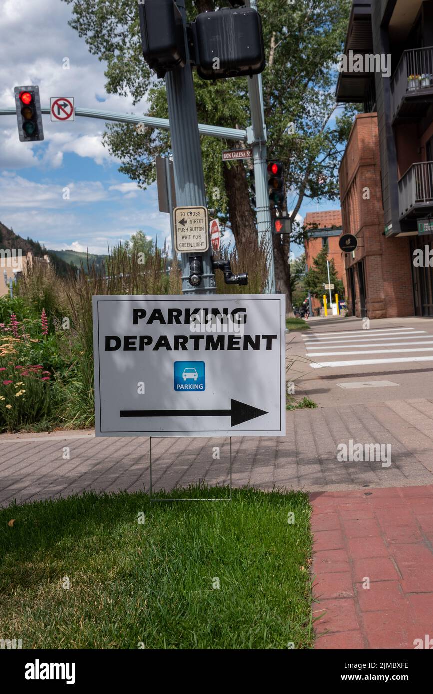 A sign with an arrow points to the Parking Department in Aspen, Pitkin ...
