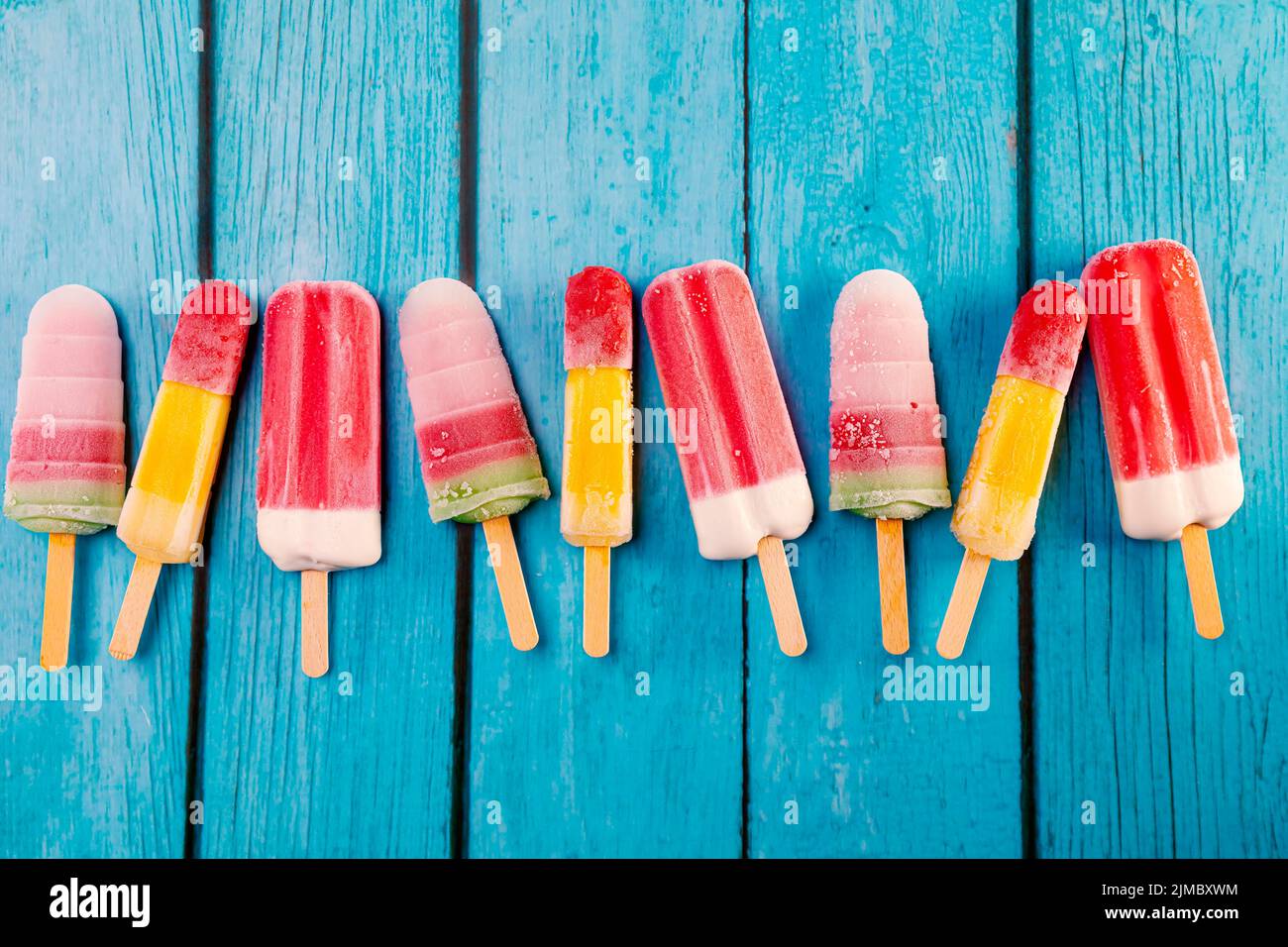 Ice cream stick placed on a blue vintage wooden Stock Photo - Alamy