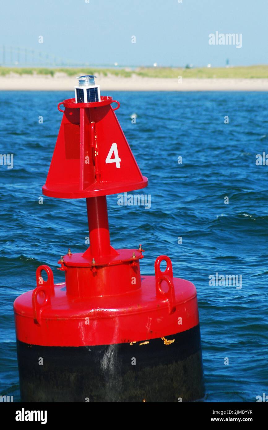 Red Buoy 4 bobs in the waters of the bay, marking the channel and the ...
