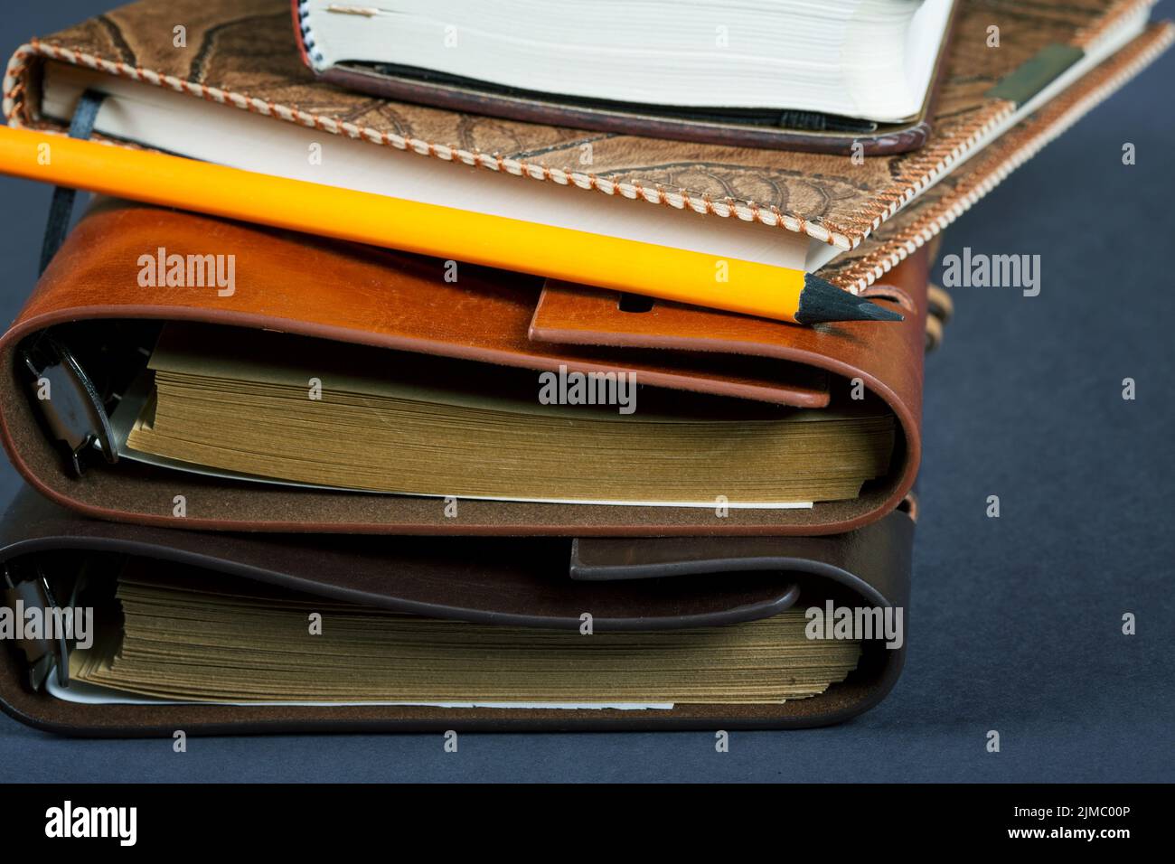 Pile of notebooks in leather covers and a pencil close up Stock Photo ...